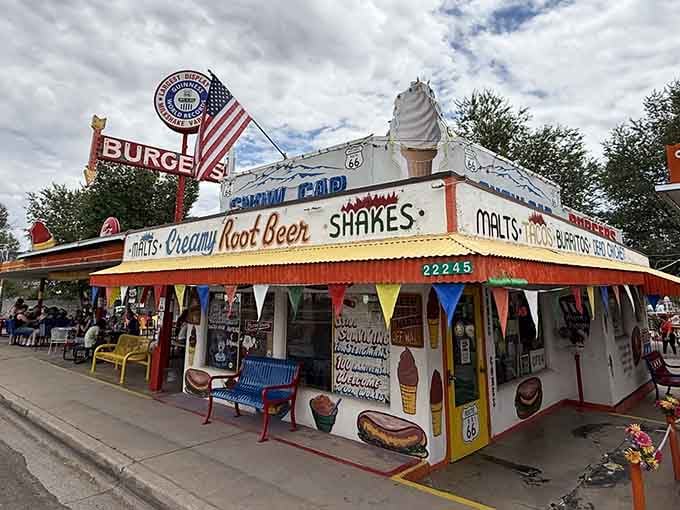 Colorful bunting and vintage signage make this roadside stop feel like a perpetual summer celebration.