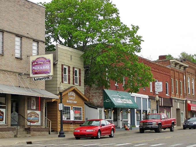 Small-town charm meets practical living where pizza shops and hardware stores share space in century-old buildings.