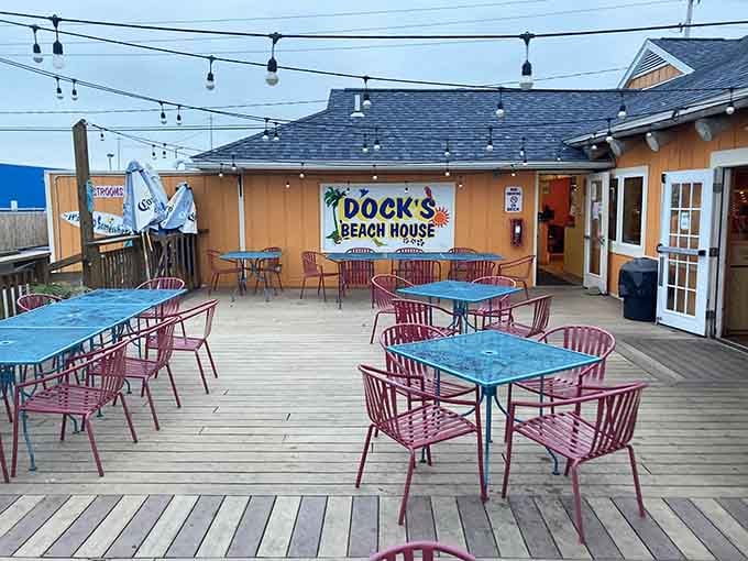 String lights overhead and colorful chairs on the deck create the perfect spot for sunset dining by the water.