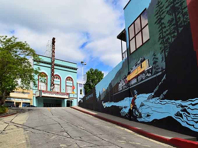 Street art meets small-town charm where murals transform ordinary walls into windows to another world entirely.