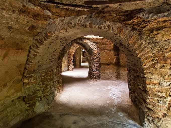 Hand-carved tunnels wind beneath the earth, creating cool passageways that feel like discovering a secret Mediterranean village.