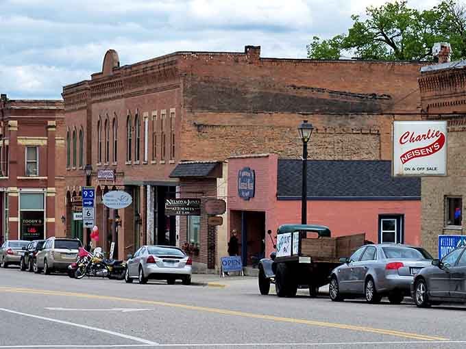 Charlie Neisen's bold red sign on that warm salmon-pink building is the kind of landmark that tells you exactly where the locals go.