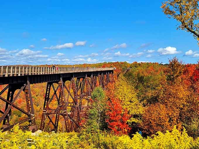 Autumn transforms the bridge into a postcard, with fall colors painting the valley in nature's boldest palette.