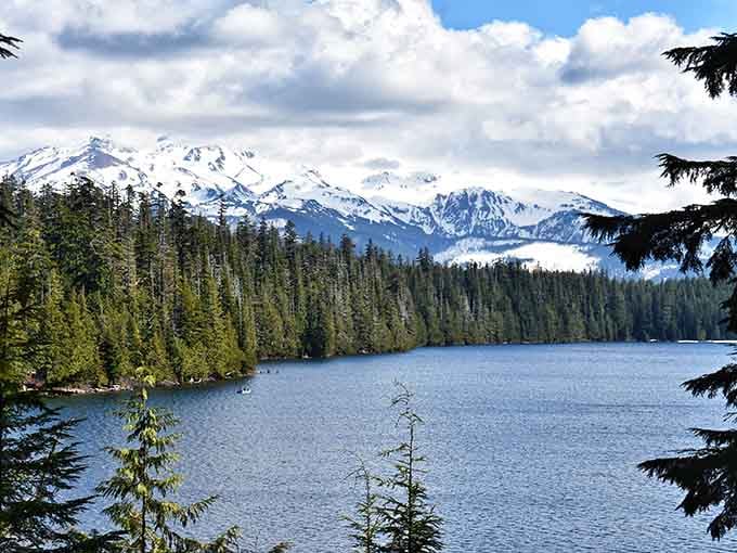 Snow-capped peaks frame the crystalline water, creating a postcard view that never gets old no matter how long you stare.