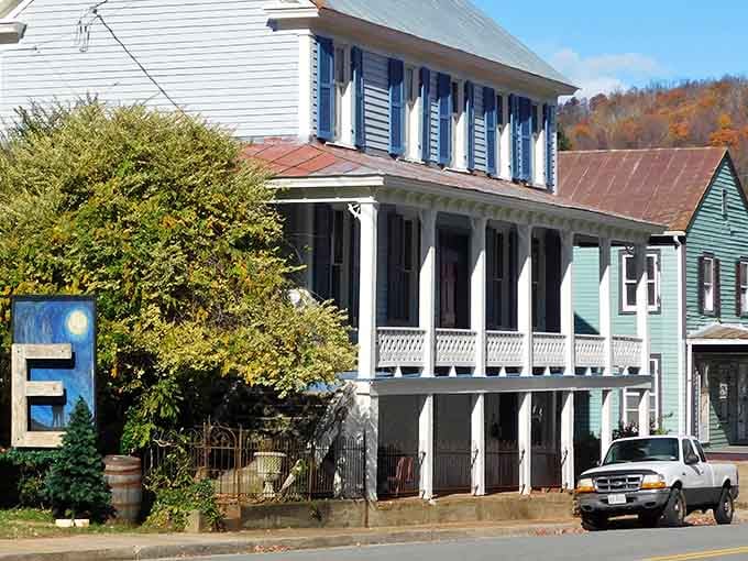 Admire the beautiful architecture of this vintage home, featuring classic blue shutters and a grand, two-story wrap-around porch for relaxing.