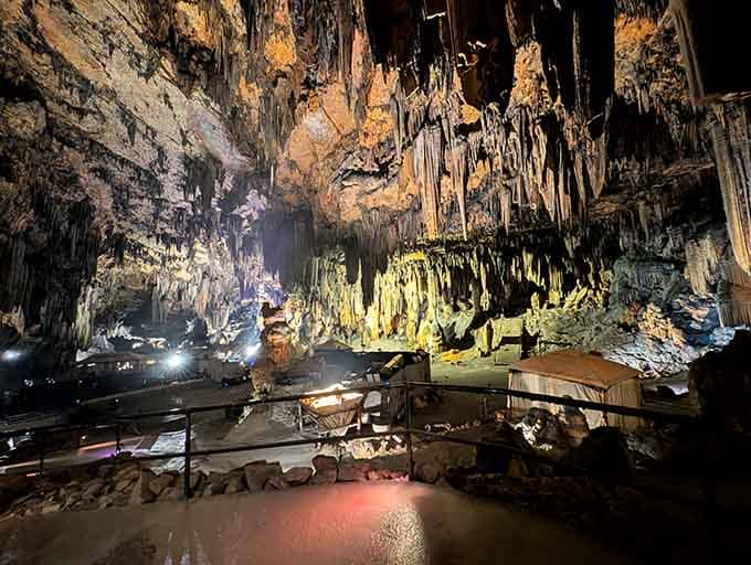 Golden hour happens underground here, where dramatic lighting transforms limestone into a glowing masterpiece of geological wonder.