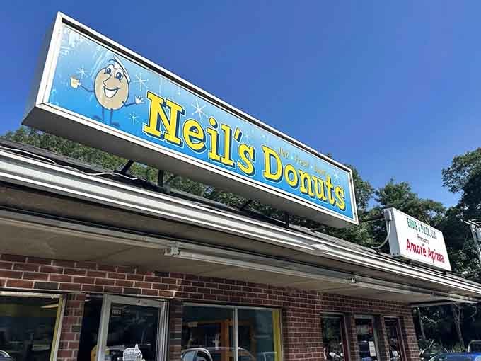 Under blue skies, this classic brick building stands ready to fuel your morning with sugary perfection.