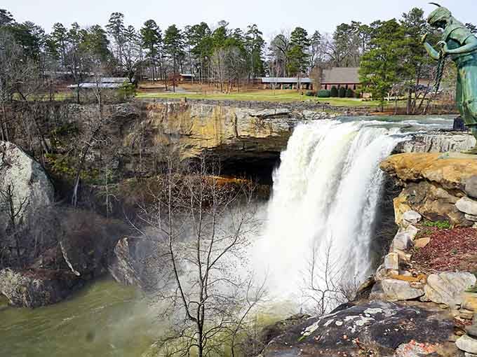 The statue watches over these cascading waters like a guardian of Alabama's most dramatic natural stage.