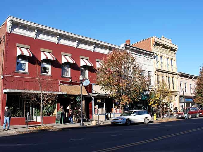 Autumn colors frame these storefronts beautifully, creating that cozy small-town vibe we all secretly crave inside.