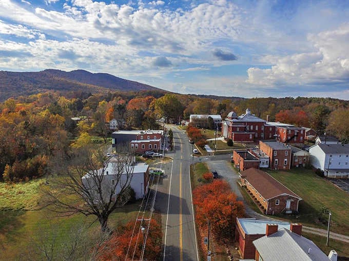 Small-town charm meets mountain majesty in this aerial view that looks like a Norman Rockwell painting come alive.