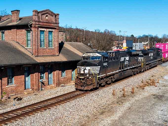 That gorgeous brick depot stands proud beside active tracks, proving some things are built to last forever.