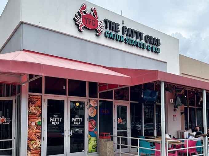 The Fatty Crab's bright pink awning practically shouts "come get messy with some delicious seafood" from across the parking lot.