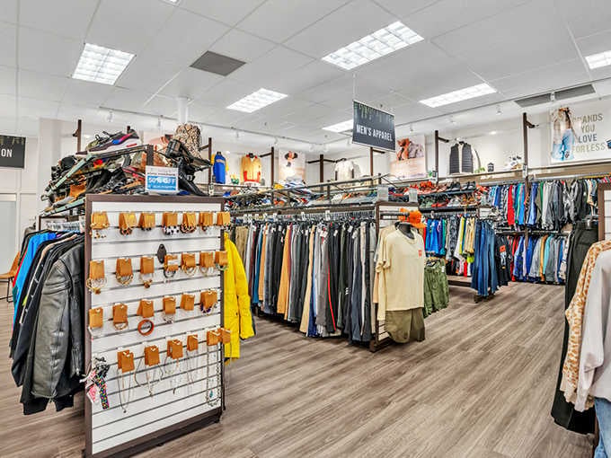 Leather jackets, belts, and a "Men's Apparel" sign overhead &mdash; this boutique-style setup makes secondhand shopping feel genuinely exciting.