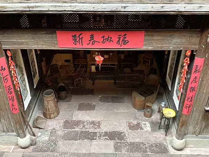Traditional red banners frame doorways in this authentic Chinese home, transported across oceans to find new life here.