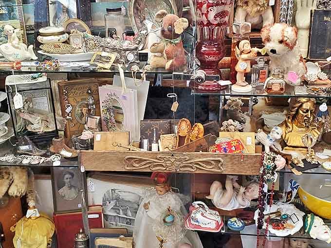 Every shelf tells a different story, from porcelain figurines to vintage glassware that survived multiple generations.