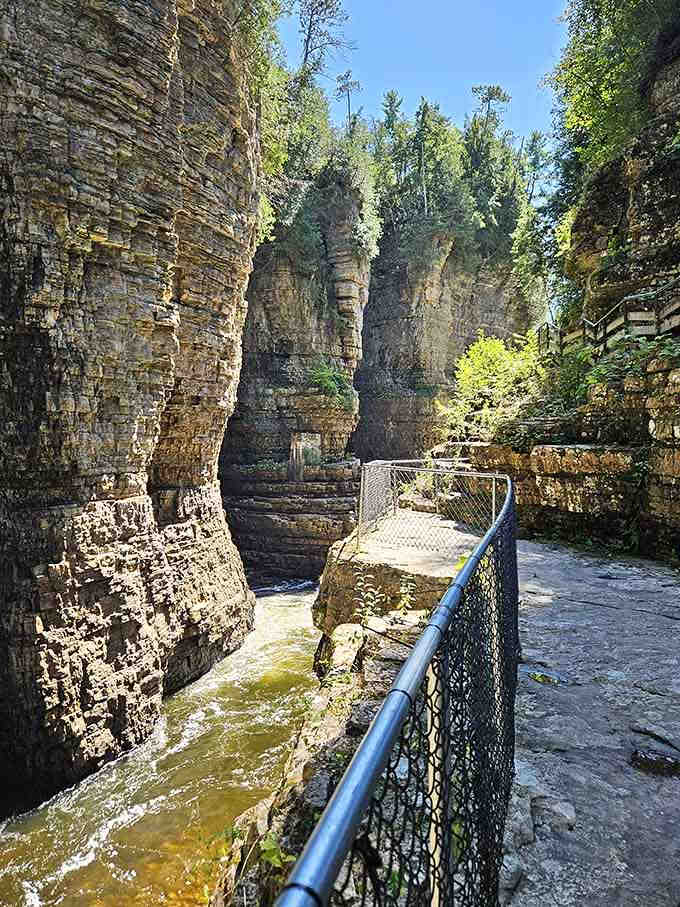 Metal walkways cling to canyon walls, offering front-row seats to nature's most impressive architectural achievement.