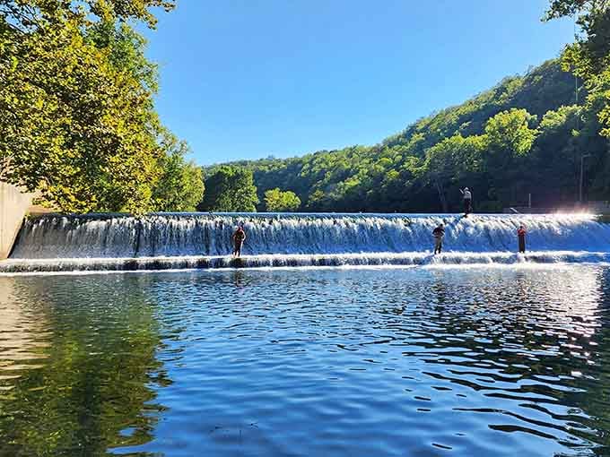 A hundred million gallons daily creates this liquid curtain where anglers stand like patient sentries awaiting their prize.