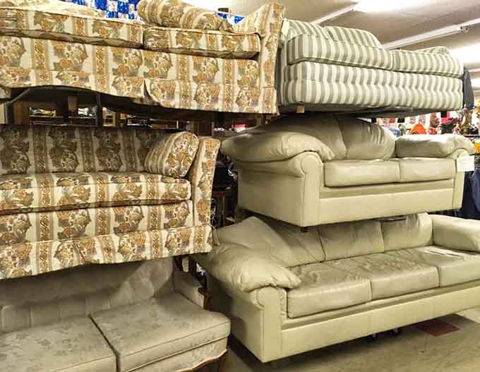 Couches stacked like a furniture Jenga game, proving that comfort comes in all patterns, even gloriously retro floral prints.