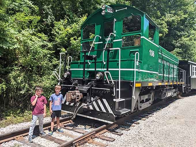 When kids pose this confidently next to a green locomotive, you know the train's already won their hearts before departure.