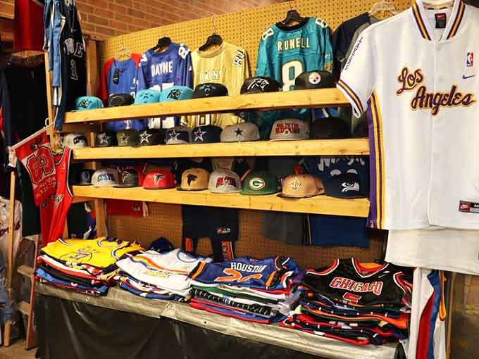 Sports fans, prepare to lose your minds over this wall of jerseys and caps representing every team loyalty crisis you've ever had.