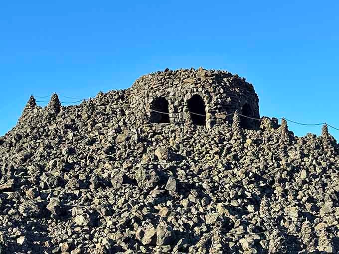 Hand-stacked lava rock creates windows to infinity, framing mountains like nature's own art gallery installation.
