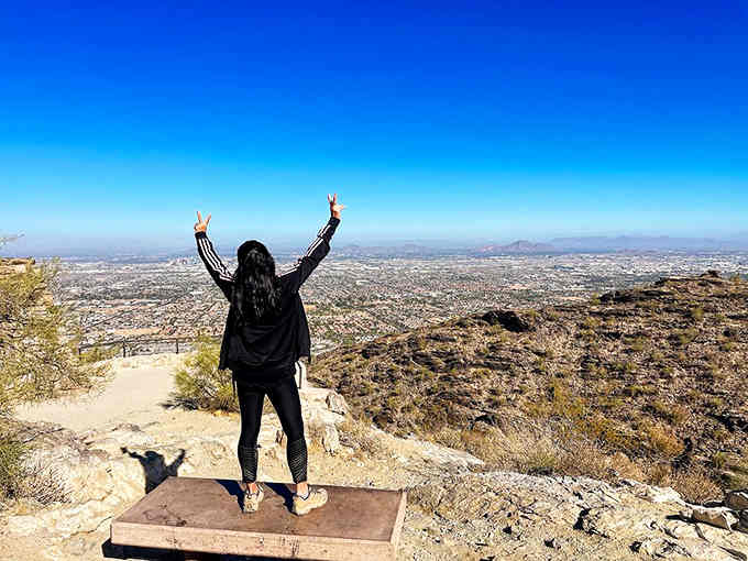 Arms raised in victory because you just discovered the view that's been hiding above the city all along.