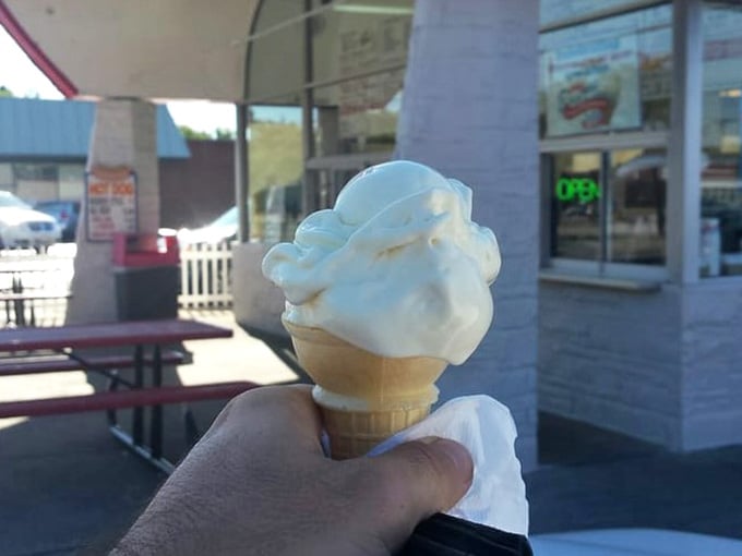 This towering vanilla cone proves that sometimes the simplest pleasures are the most profoundly satisfying ones.
