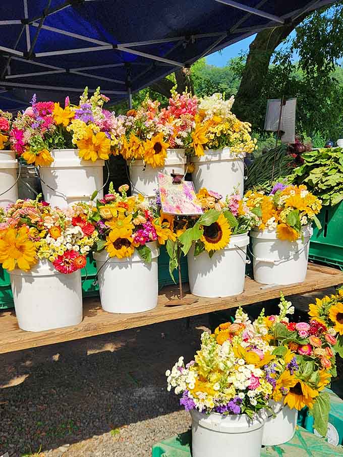 Fresh blooms bursting from white buckets prove that not everything here is vintage, just beautifully curated.