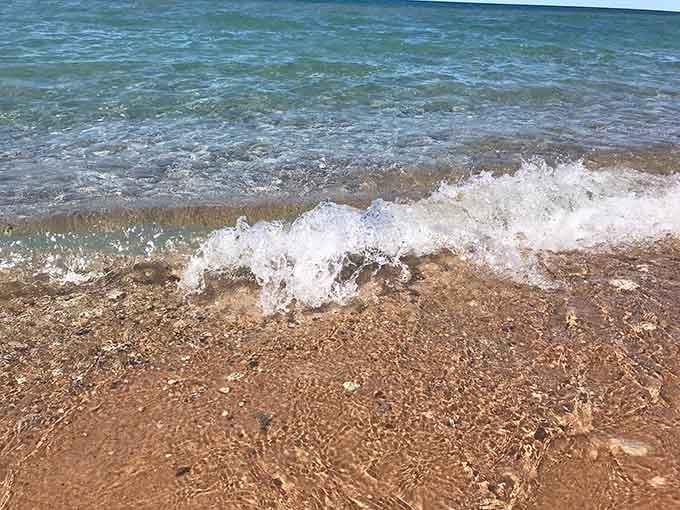 Crystal-clear water revealing every pebble beneath the surface, because Lake Michigan doesn't believe in keeping secrets.