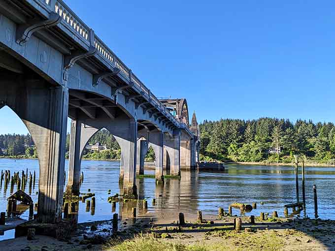 The historic Siuslaw River Bridge stands proud, its Art Deco arches reflecting in calm waters below.