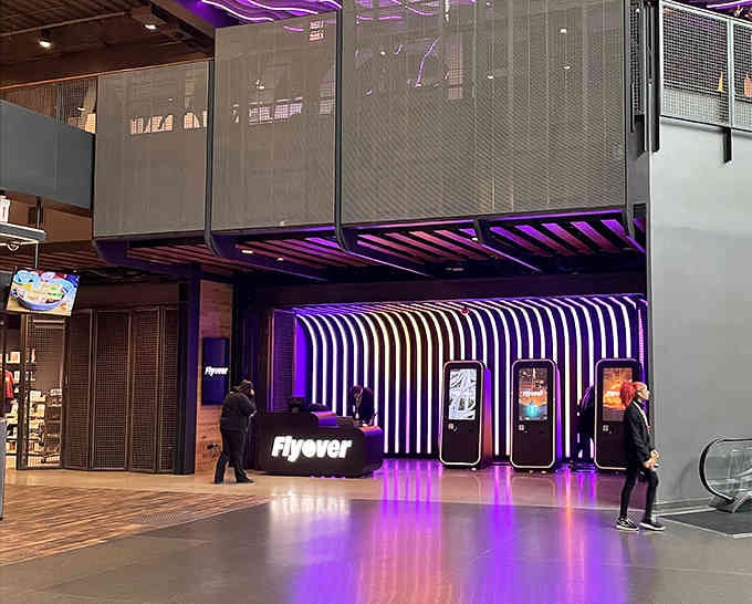 Modern design meets futuristic vibes at the ticket booth, where your journey to defying gravity officially begins.