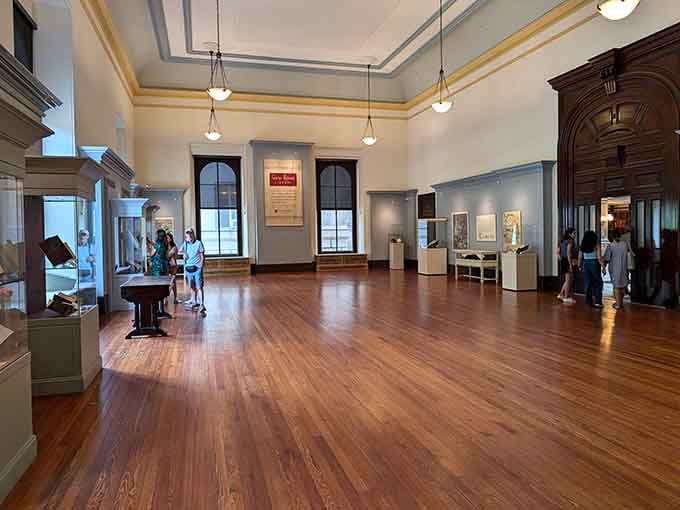 Gleaming hardwood floors stretch across exhibition spaces where history whispers from every carefully curated display case nearby.