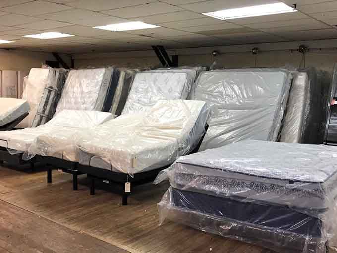Rows of wrapped mattresses ready to transform your sleep without requiring a bank loan first.