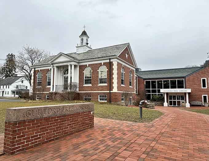 The Guilford Free Library anchors the town green with classic New England architecture that commands respect without demanding attention.