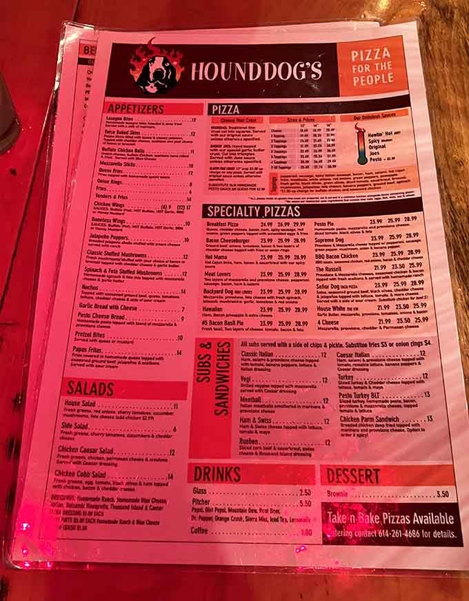 The pink menu is your roadmap to happiness, featuring everything from classic pies to creations that defy pizza logic.