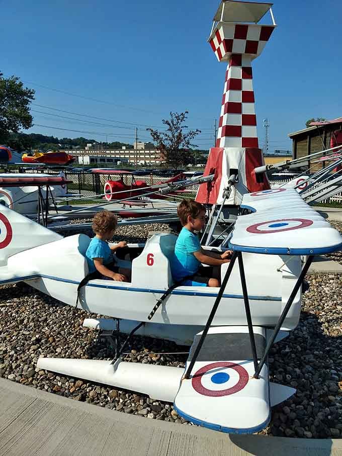 Future pilots take their maiden voyage around a lighthouse, steering with the serious concentration of actual aviators.