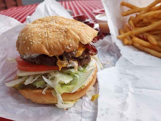 Behold the burger that launched a thousand return visits, stacked high with fresh toppings and zero pretension whatsoever.