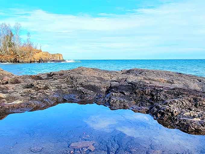 Tide pools reflecting the sky create natural mirrors that make you question which way is up.