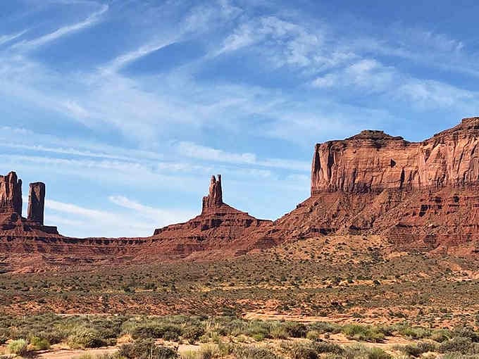 Monument Valley's greatest hits album, all visible from one perfectly positioned scenic overlook along the route.