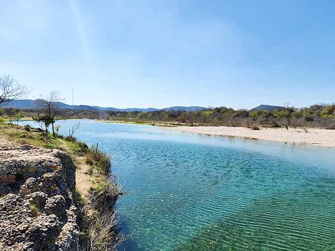 The Nueces River stretches out like liquid turquoise, proving Texas has serious hidden talents beyond barbecue.