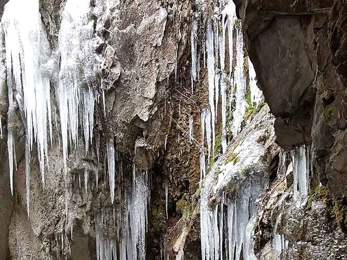 Winter transforms the cavern entrance into an icy wonderland that looks like Elsa's vacation home went underground and got serious.