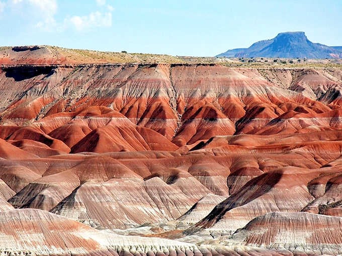 Those red hills aren't blushing, they're just showing off millions of years of iron oxide doing its colorful thing.