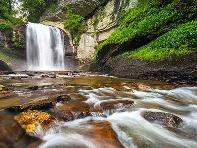 Water rushing over colorful rocks creates nature's own abstract art installation, no gallery admission required.