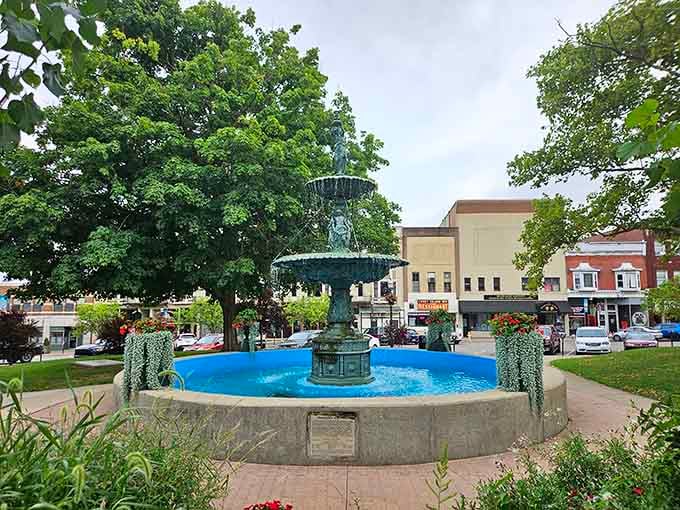 That blue fountain isn't just pretty, it's the town's gathering spot where community actually means something beyond a Facebook group.