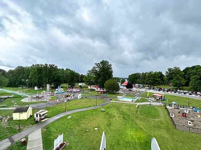 Sprawling lakeside grounds dotted with vintage rides and mature trees, this aerial view captures small-town charm at its finest.