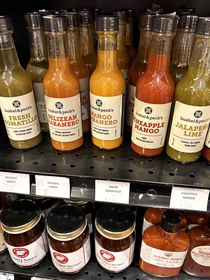 Hot sauce bottles arranged by heat level, from "Sunday brunch pleasant" to "call your mother to say goodbye."