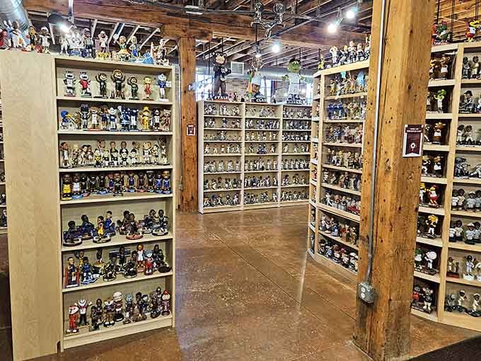 Floor-to-ceiling shelves create a maze of bobbleheads, each aisle revealing another chapter in America's love affair with spring-mounted heads.