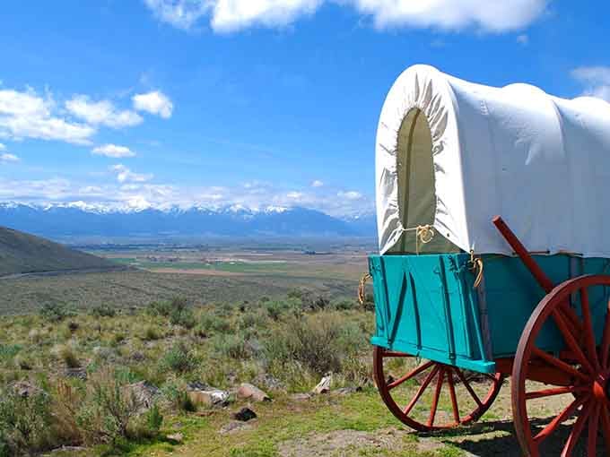 That turquoise wagon against snow-capped peaks proves pioneers had an eye for color, even while facing certain hardship.