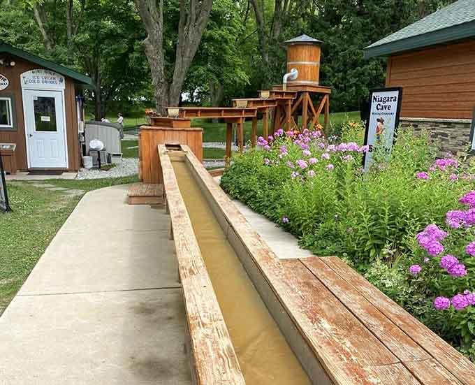That wooden sluice isn't just decoration; it's your chance to pan for real gemstones like a 19th-century prospector.