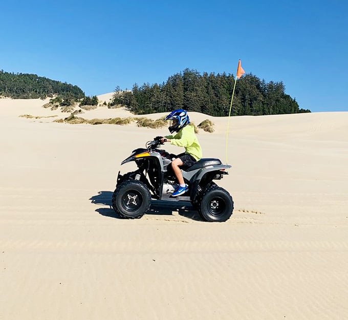 Nothing says family fun like a kid tearing across the sand on an ATV, living their best Mad Max life.